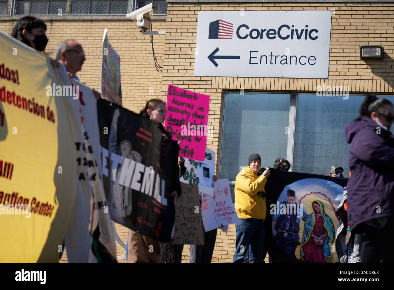 People gather in front of a migrant detention center, run by CoreCivic ...