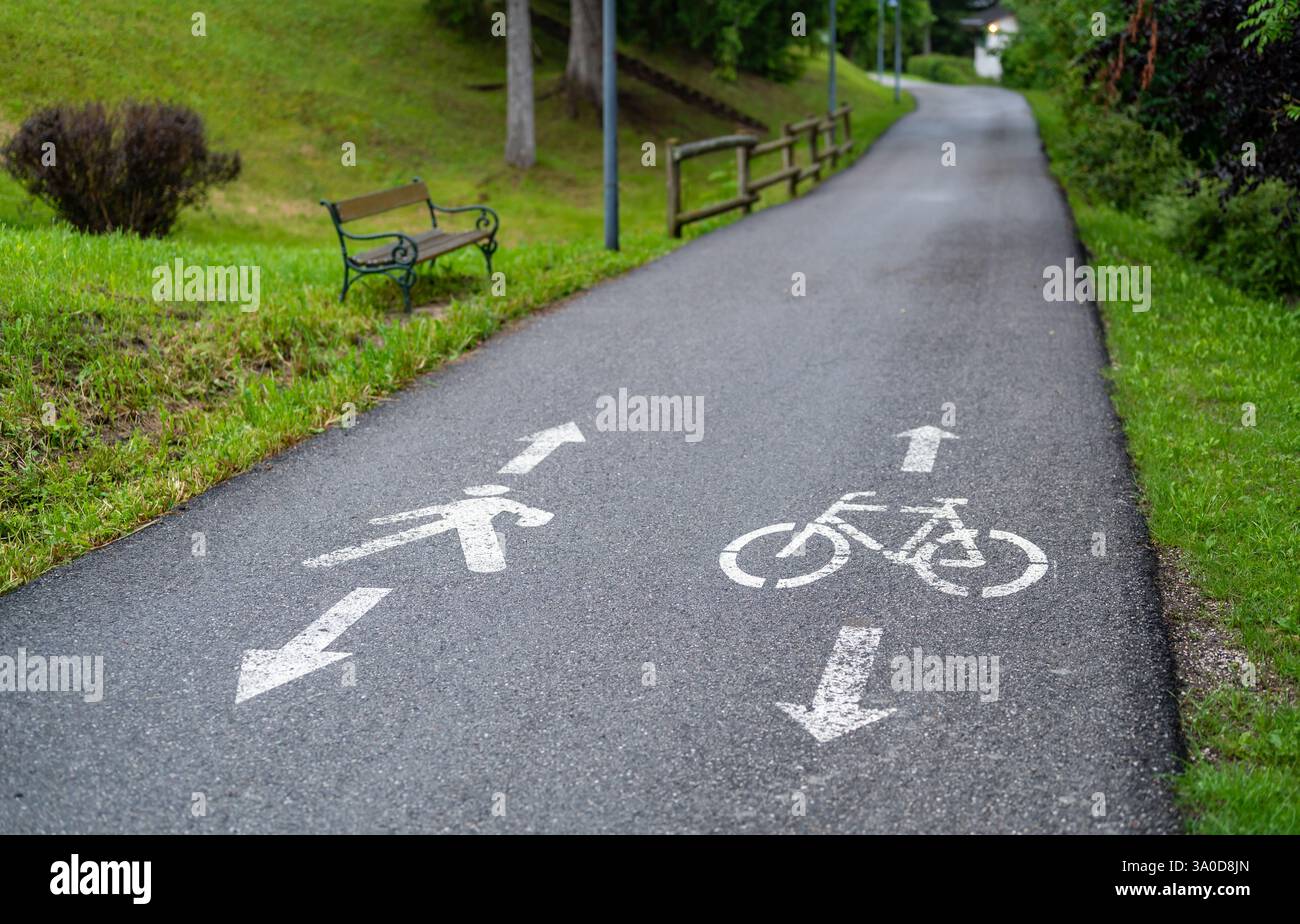 A view of an asphalt bike path with a pedestrian walkway, marked with ...
