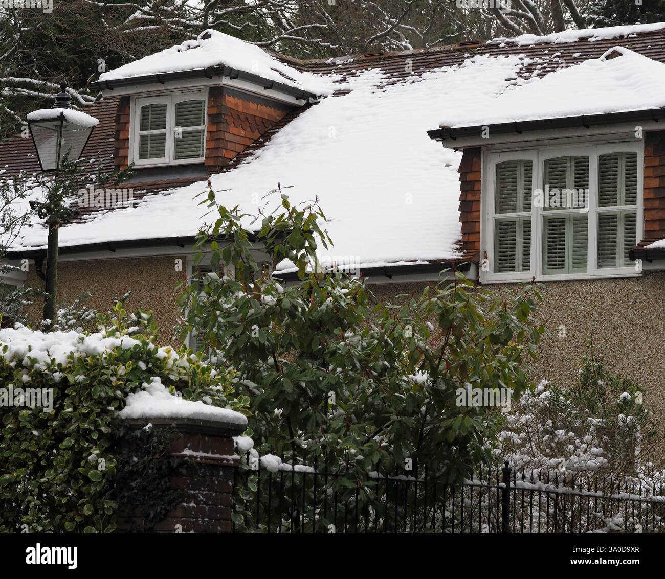 An attractive older house with pebbledashed walls and shuttered windows ...