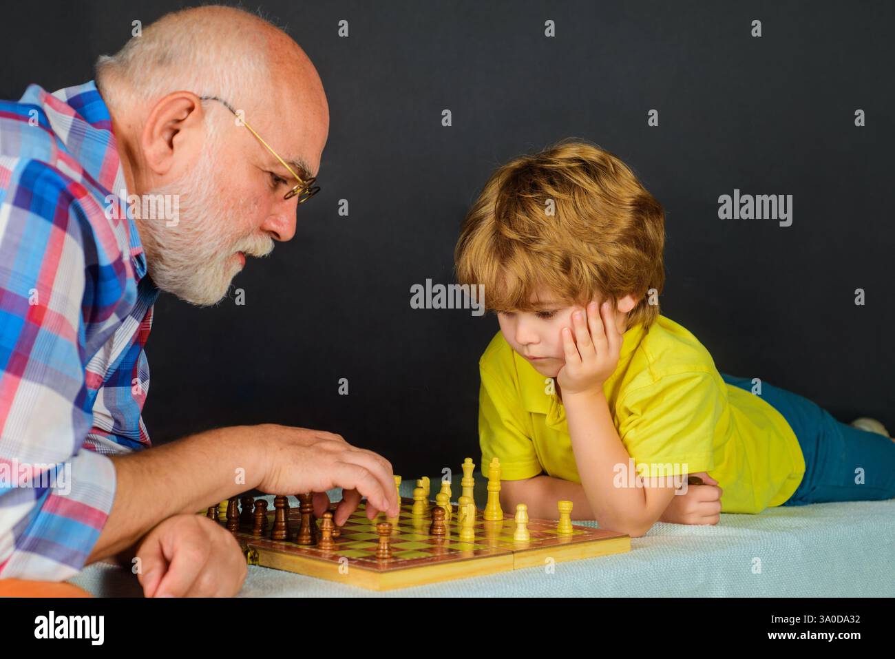 Childhood and logic board games. Grandpa teaching grandchild to play ...