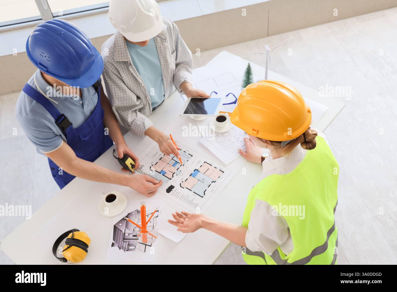 Team of constructors working with house plan at table in office Stock ...