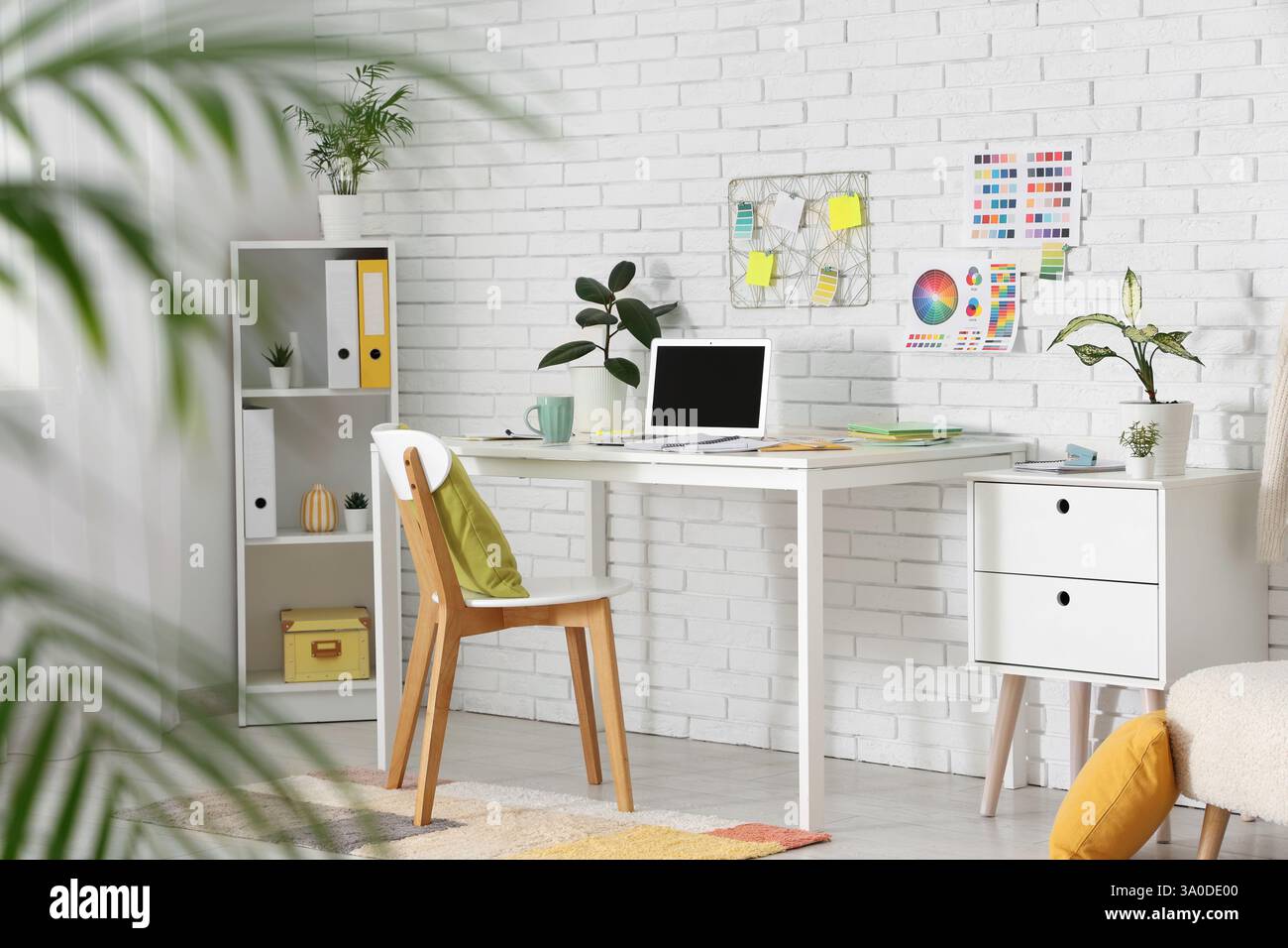Interior of designer's office with workplace and shelf unit Stock Photo ...