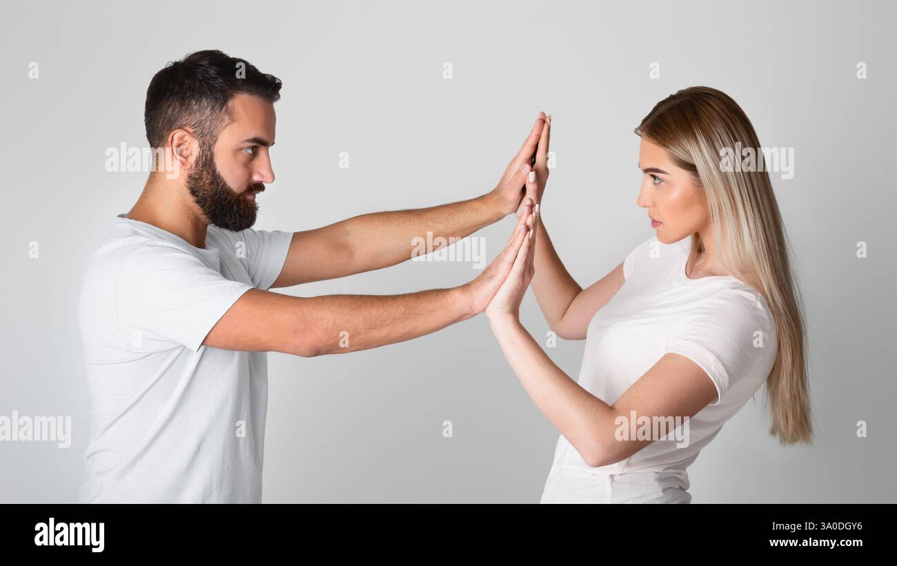 Confronting home repressor. Man presses woman with his hands, woman ...