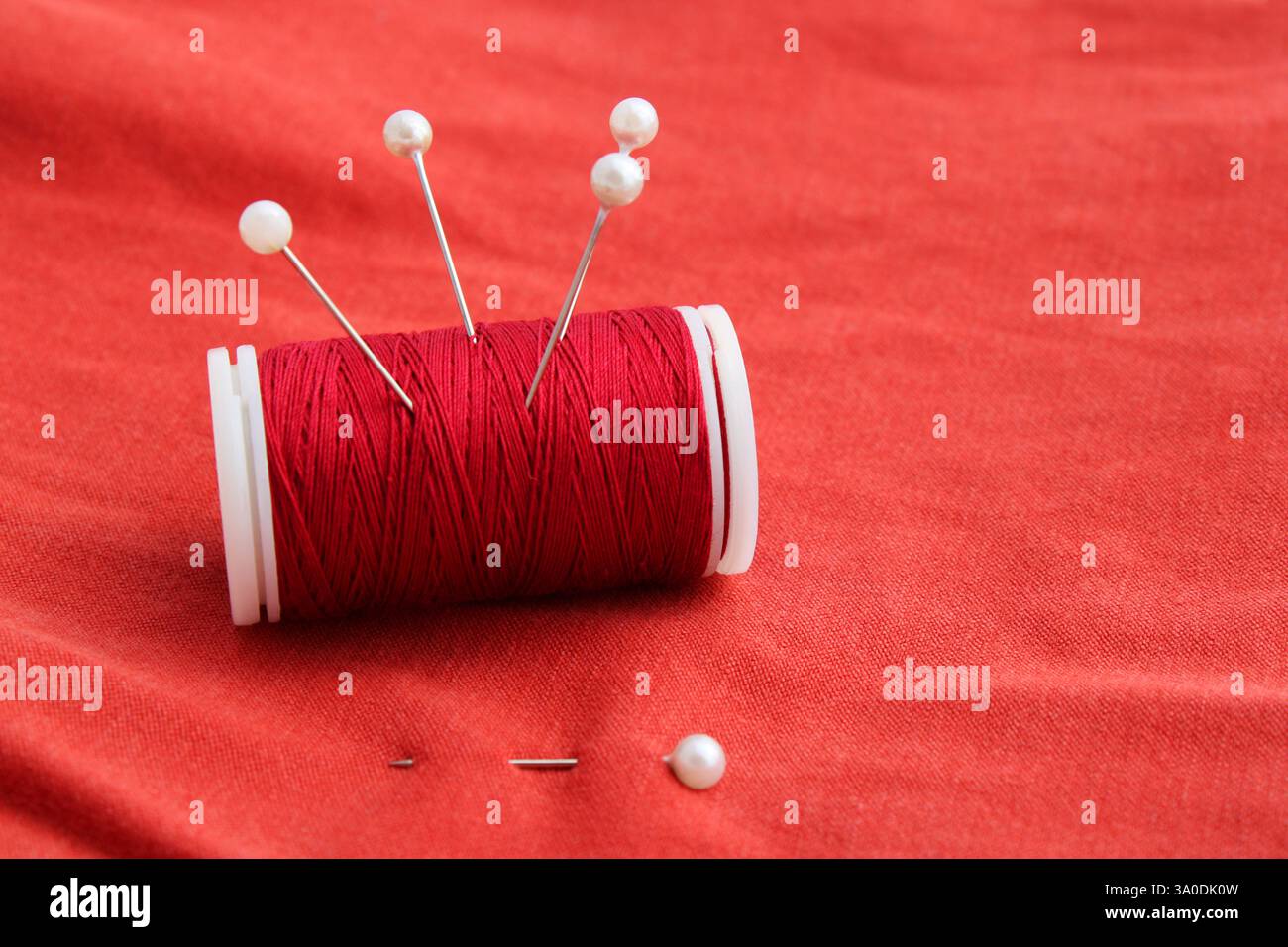 Sewing pins on a spool of thread Stock Photo - Alamy