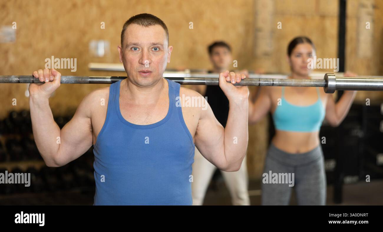 Middle-aged male bodybuilder performing strength and endurance ...