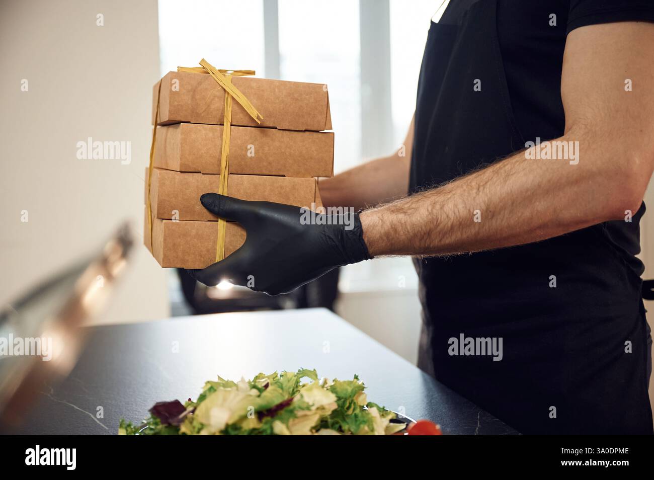 Waiter is holding bunch of paper eco boxes in the cafe. Order is ready ...