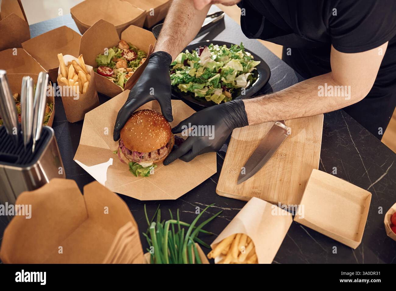 Man hands taking burger close hi-res stock photography and images - Alamy
