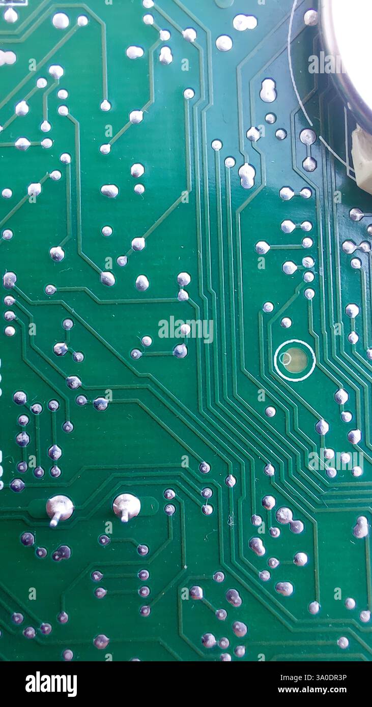 A detailed electronic board presents a complex network of circuit paths ...