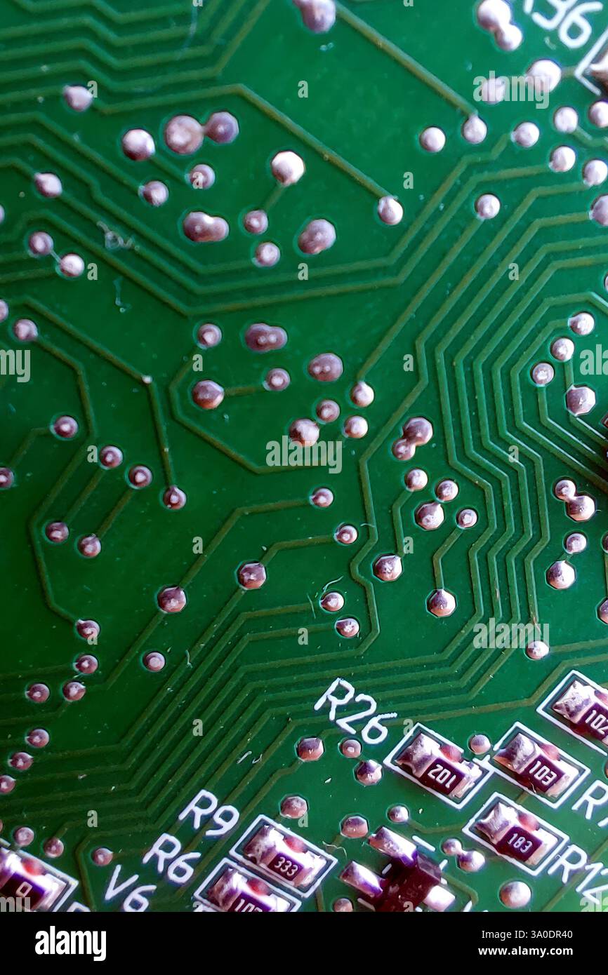 Detailed circuitry is visible on a green electronic board, highlighting ...