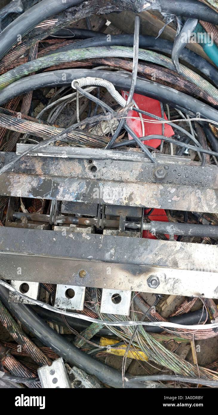 Tangle of heated electrical cables sprawls across a work surface, with ...