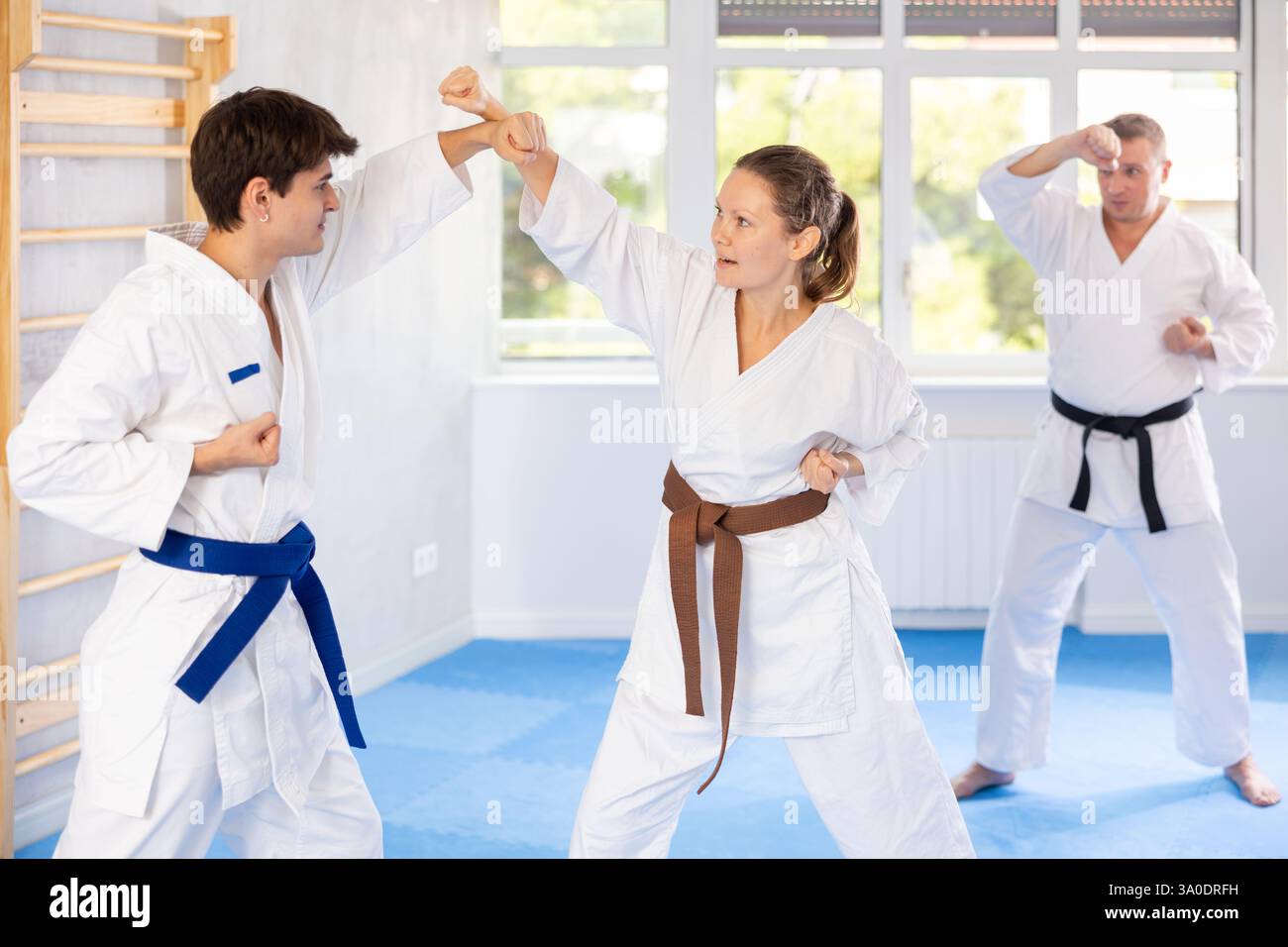 Man and woman train to perform basic defensive attacking actions during ...