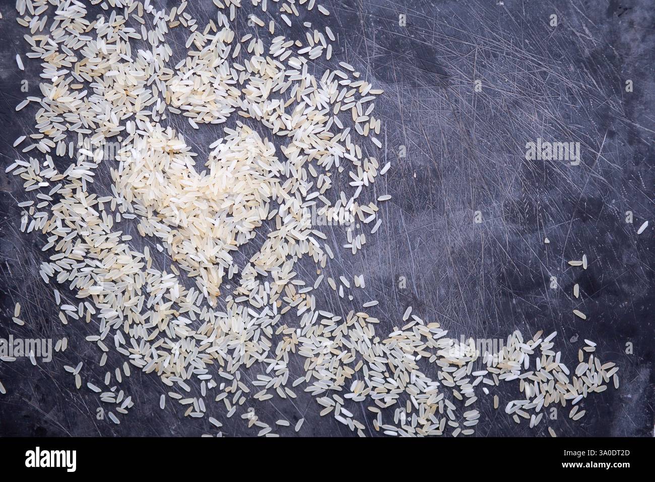 Heart Shape with short grained white rice on a black slate chopping ...