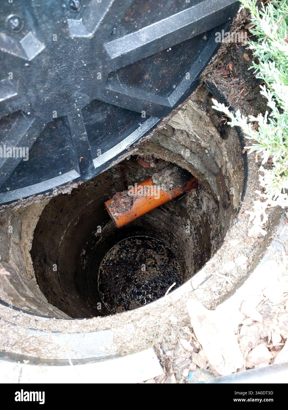 Deep within the ground lies a sewer well, revealing a glimpse of urban ...
