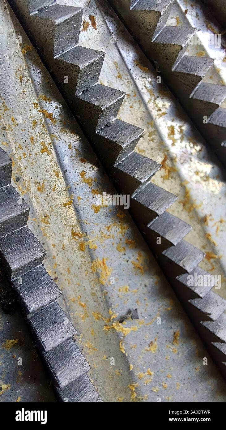 Gleaming steel knives sit ready for action within a fruit crusher ...