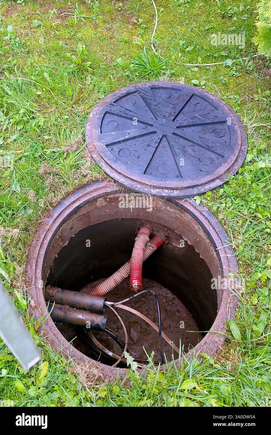 Well cables are visible inside a freshly opened access point on a lush ...