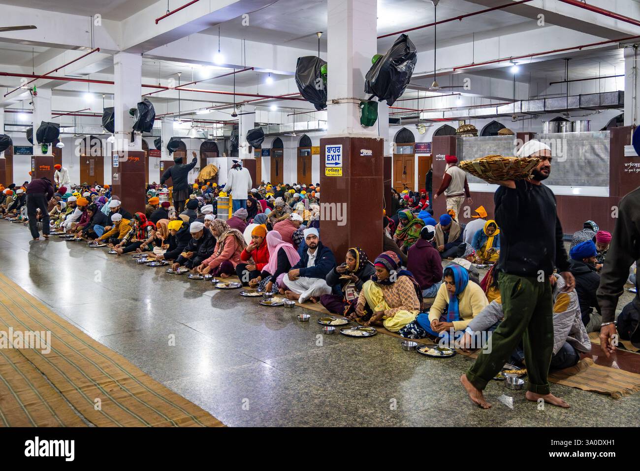 Visitors dining at the langar, a Sikh community-run kitchen offering ...