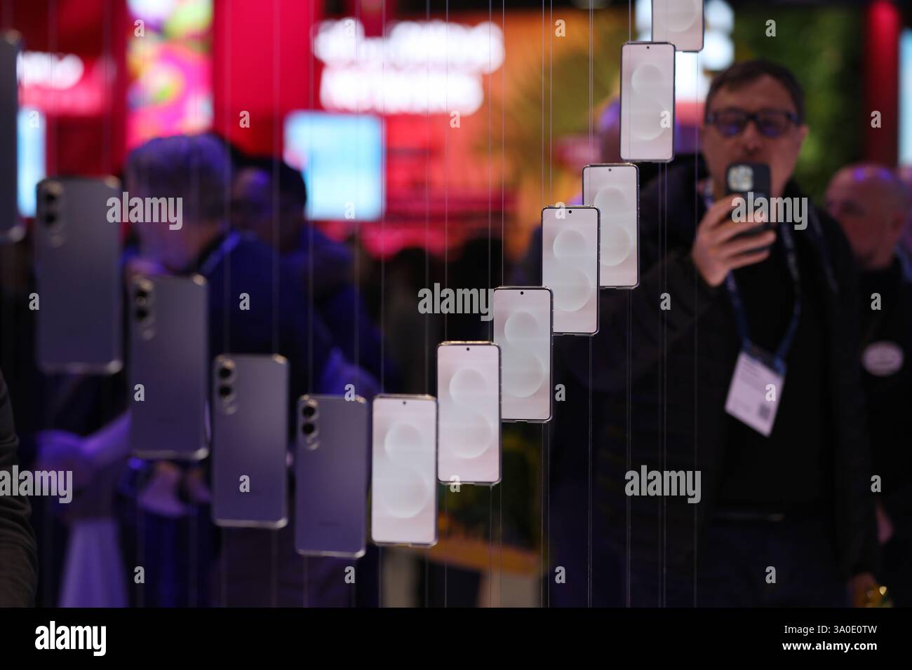 Barcelona, Spain. 3rd Mar, 2025. A man takes photos of smartphones ...