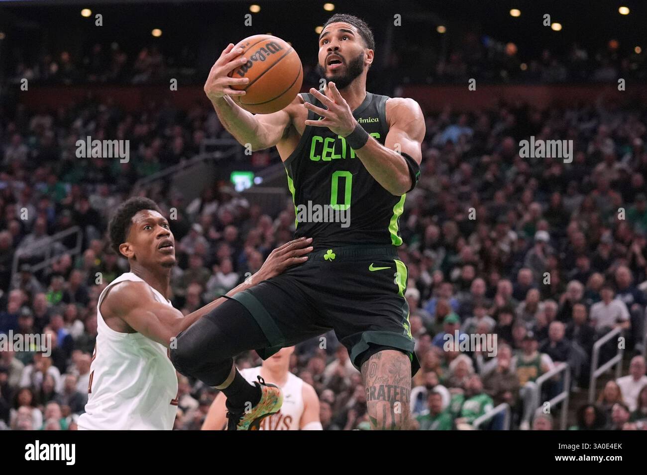 Boston Celtics forward Jayson Tatum (0) drives to the basket during an ...