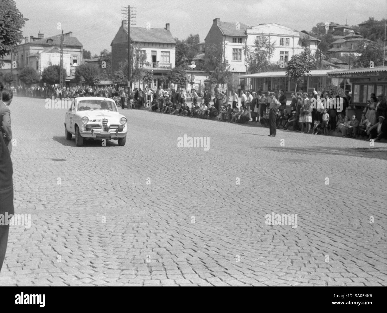 Liege-Sofia-Liege Rally, 1960s, Race car passes through the town of ...