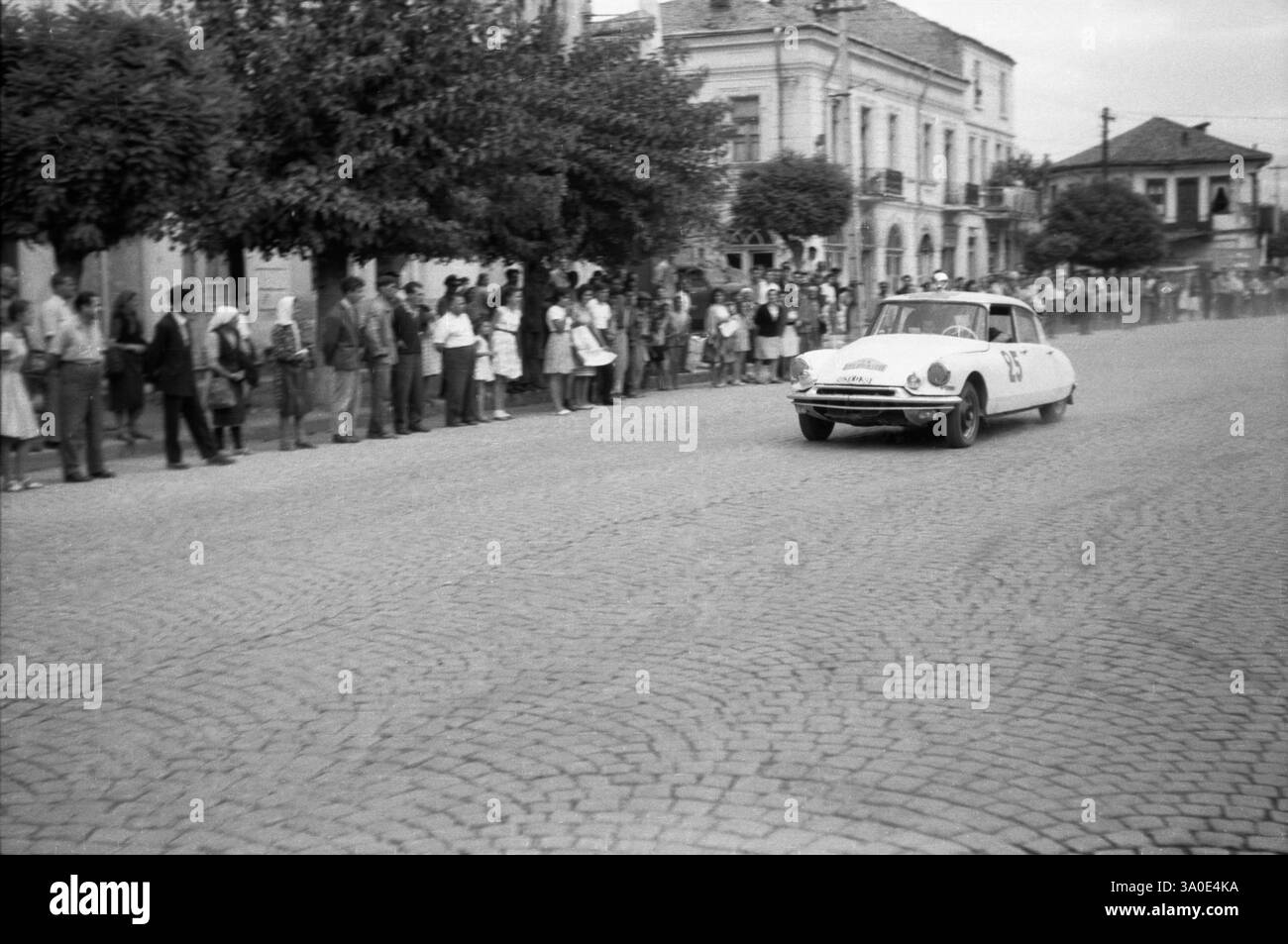 Liege-Sofia-Liege Rally, 1960s, Race car passes through the town of ...