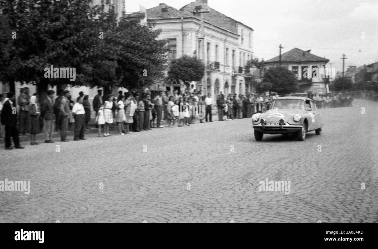 Liege-Sofia-Liege Rally, 1960s, Race car passes through the town of ...