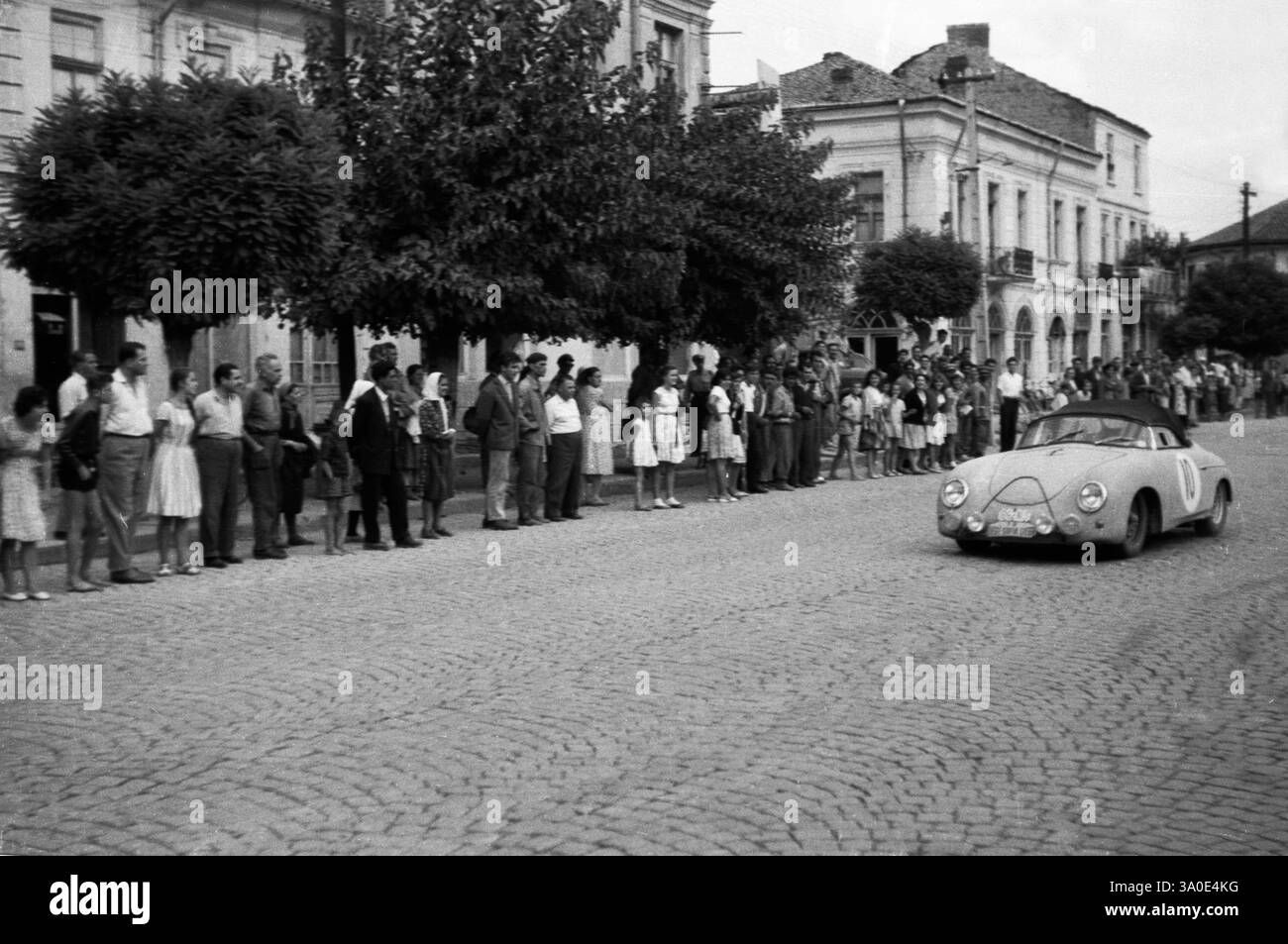 Liege-Sofia-Liege Rally, 1960s, Race car passes through the town of ...