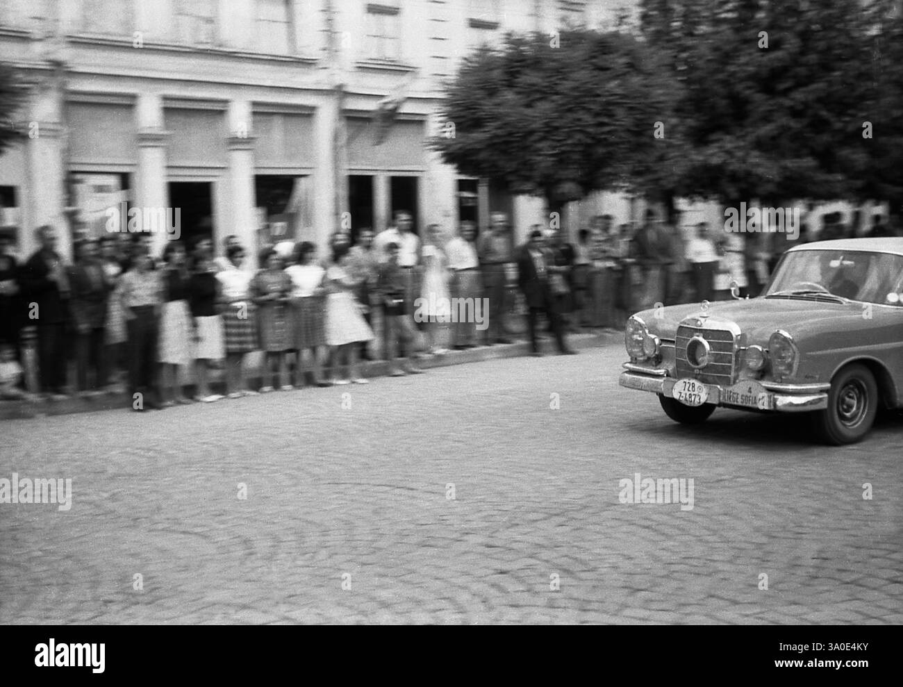 Liege-Sofia-Liege Rally, 1960s, Race car passes through the town of ...