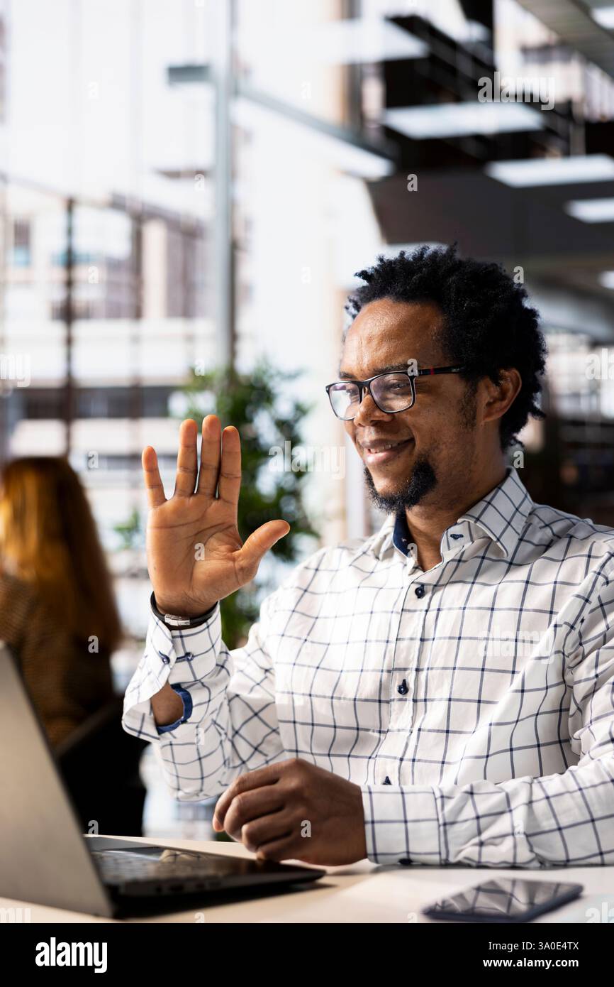 Black man employee joins a telecommuting session at his office desk ...