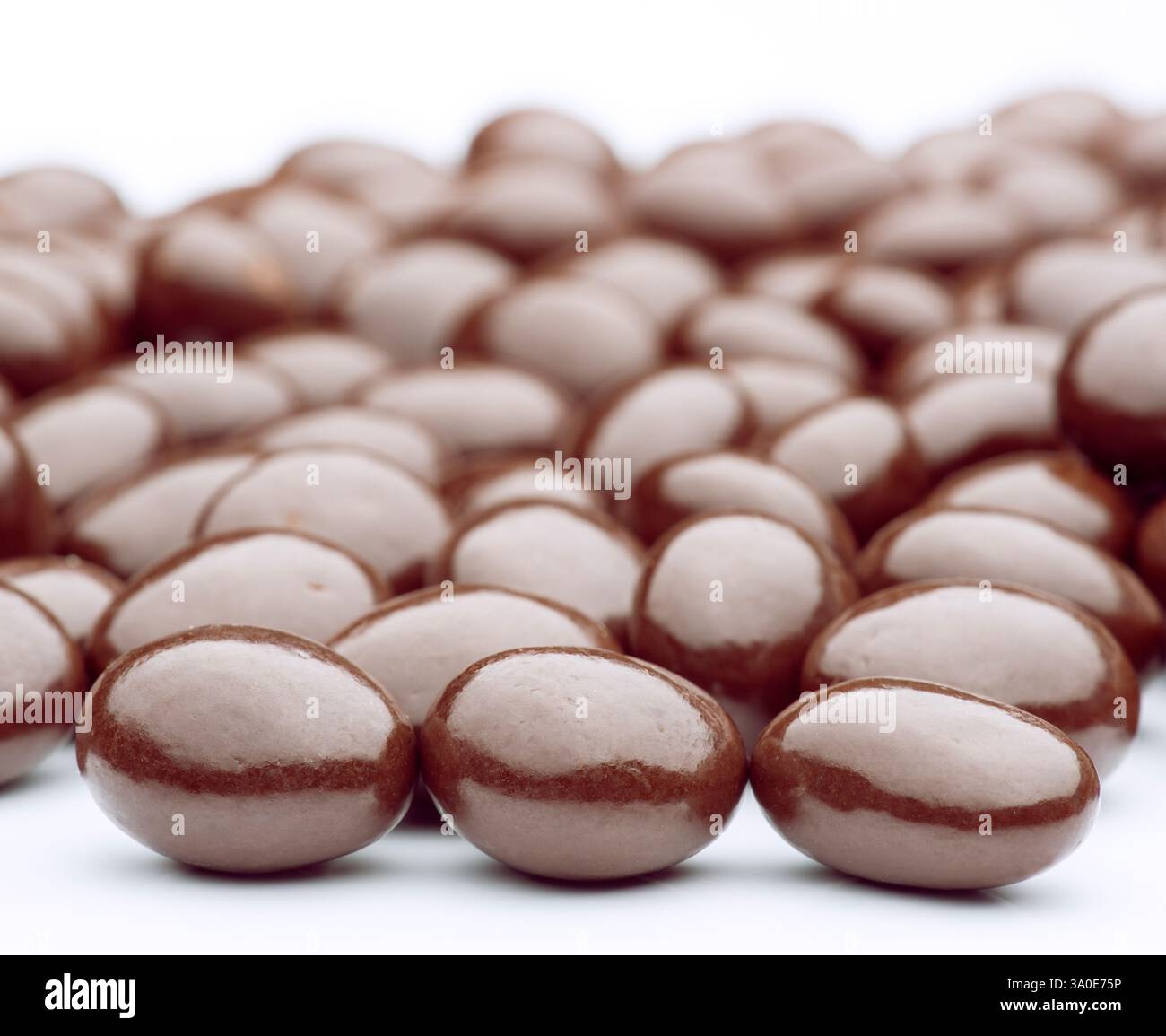 Shiny chocolate eggs arranged on a crisp white background create a ...