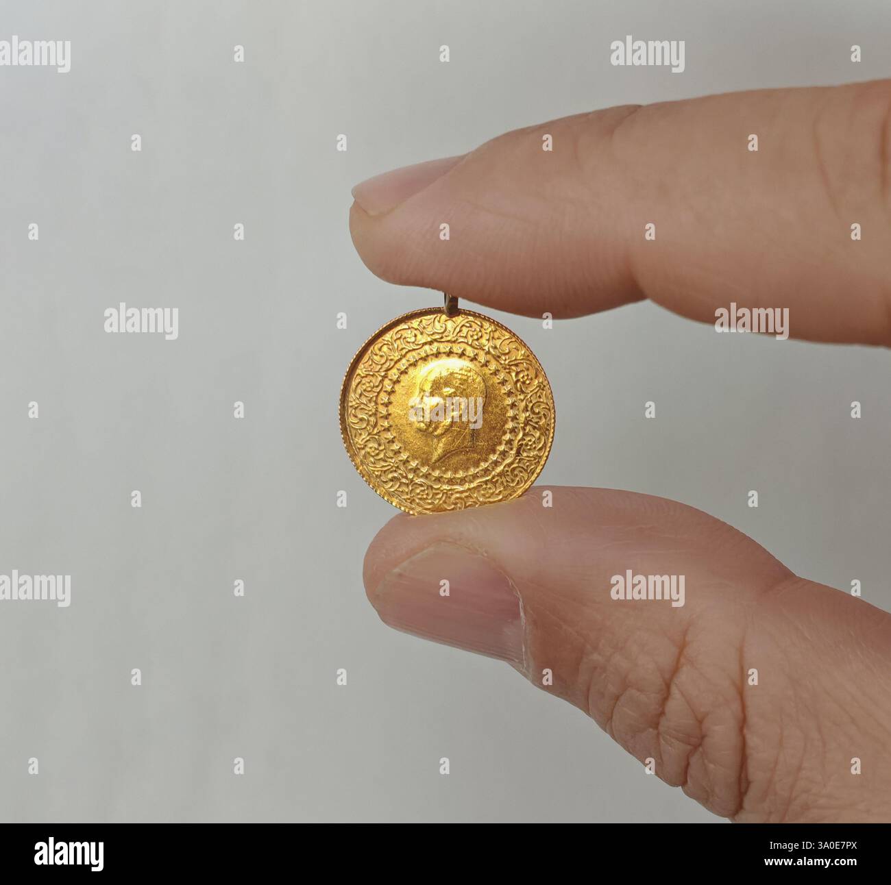 Male fingers holding 24 carat gold which people use in Turkey Stock ...