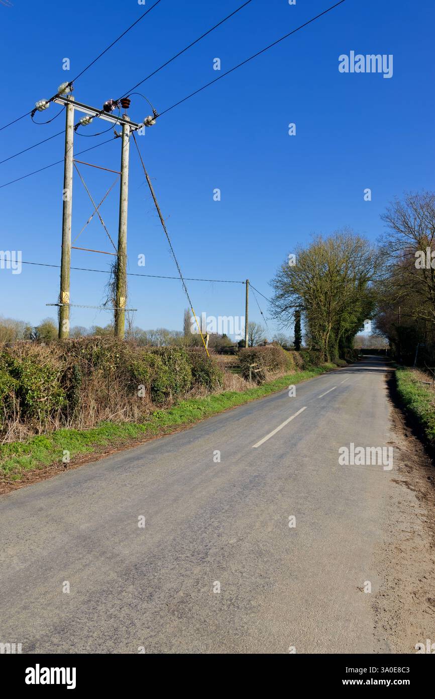 Rural road with high-voltage electricity pole as part of electric ...