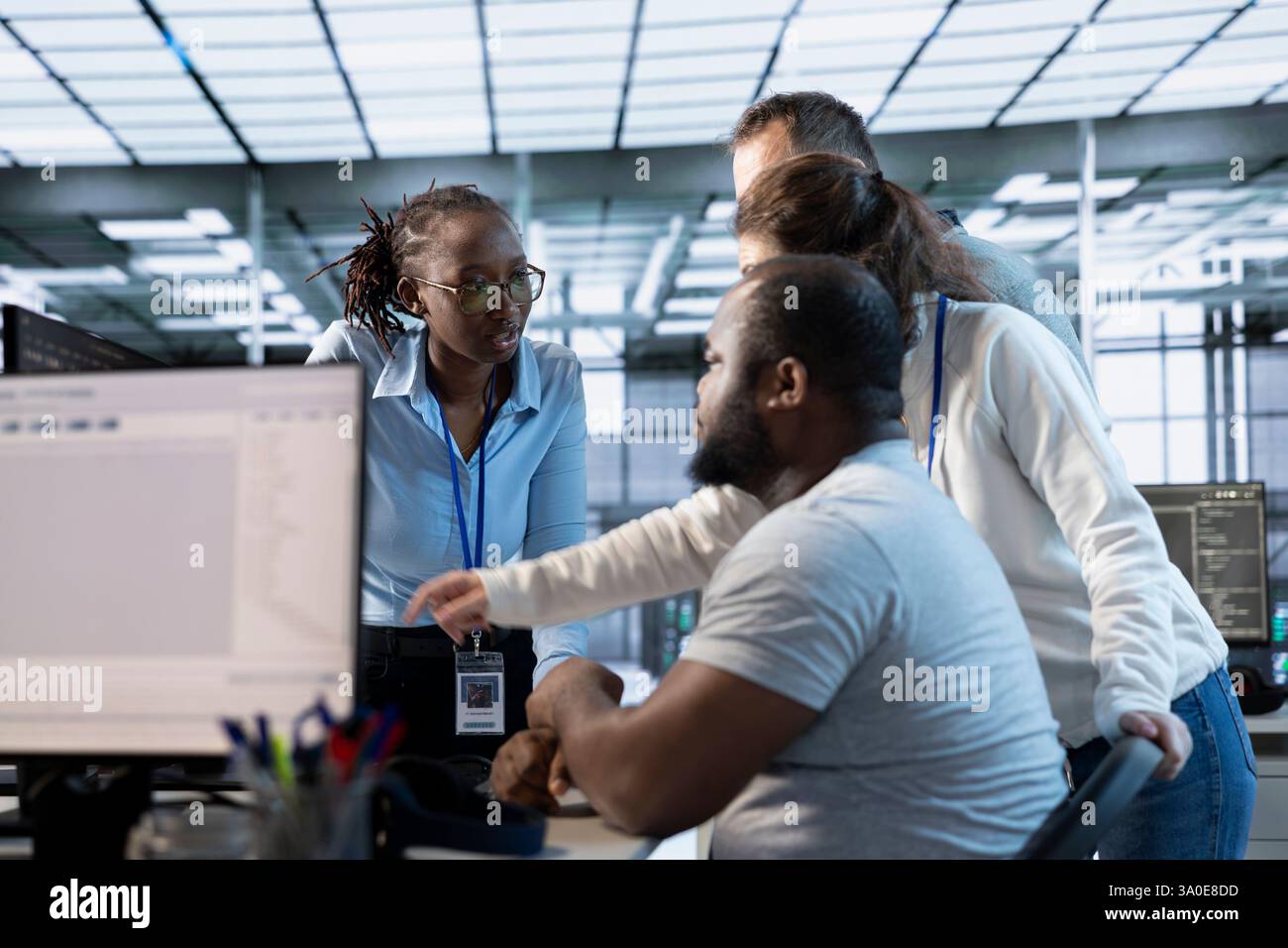 Data center admins working together hi-res stock photography and images ...