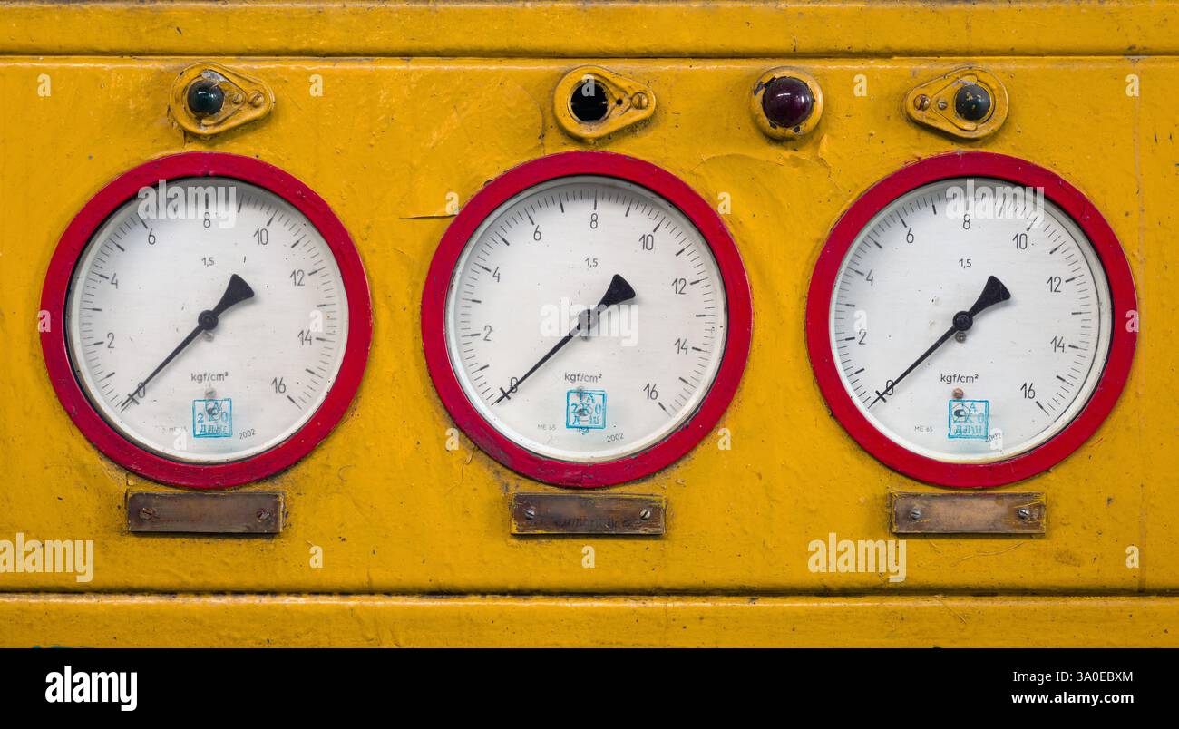 A row of industrial pressure gauges on a panel. Manometers Stock Photo ...