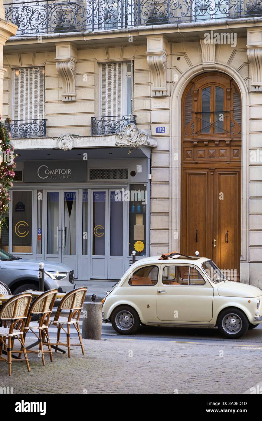 A charming and quaint Parisian street that features an old vintage car ...