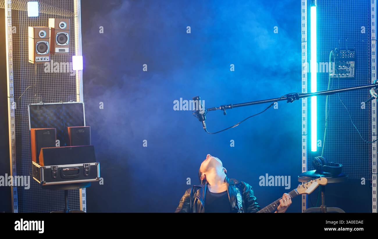 Female recording artist playing bass guitar in a nightclub concert ...