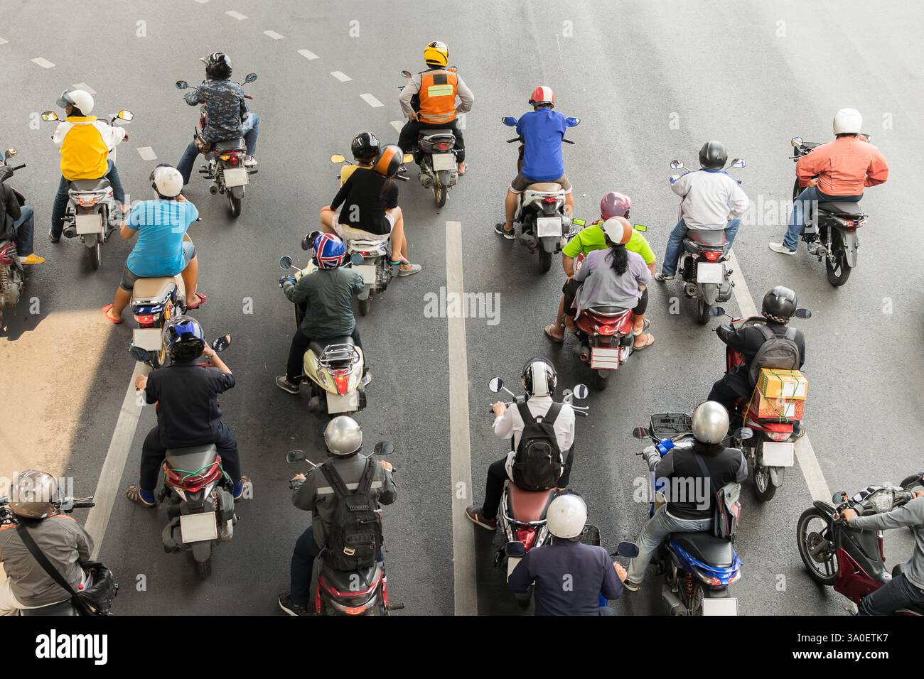 Motorcycle wait to go at intersection with traffic light on a road ...
