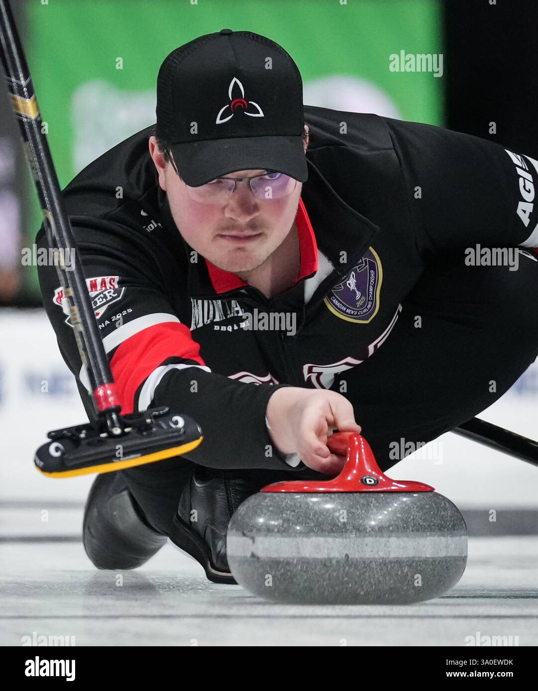 Ontario skip Sam Mooibroek delivers a rock while playing Yukon during ...