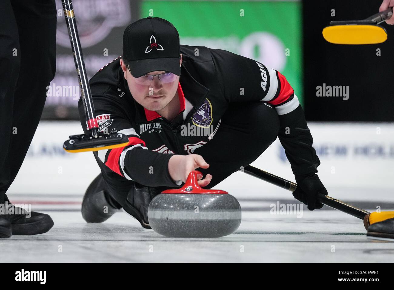 Ontario skip Sam Mooibroek delivers a rock while playing Yukon during ...
