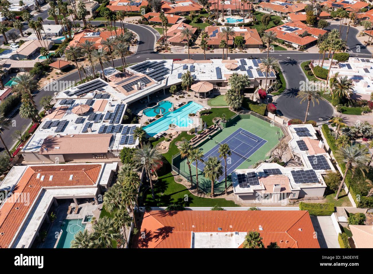 Aerial view of the back of a large home with swimming pool and a tennis ...