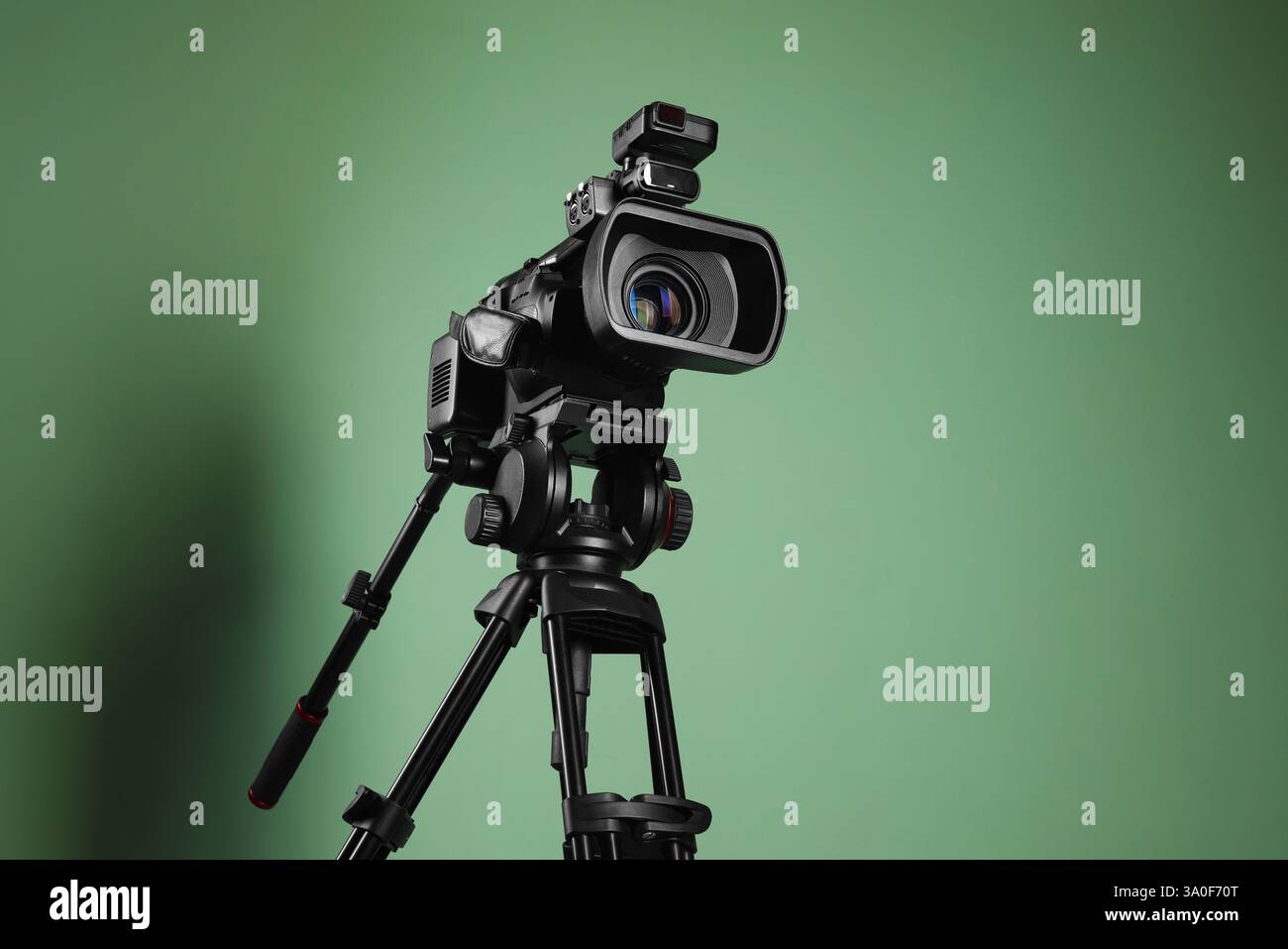 Modern professional video camera on greyish green background Stock ...