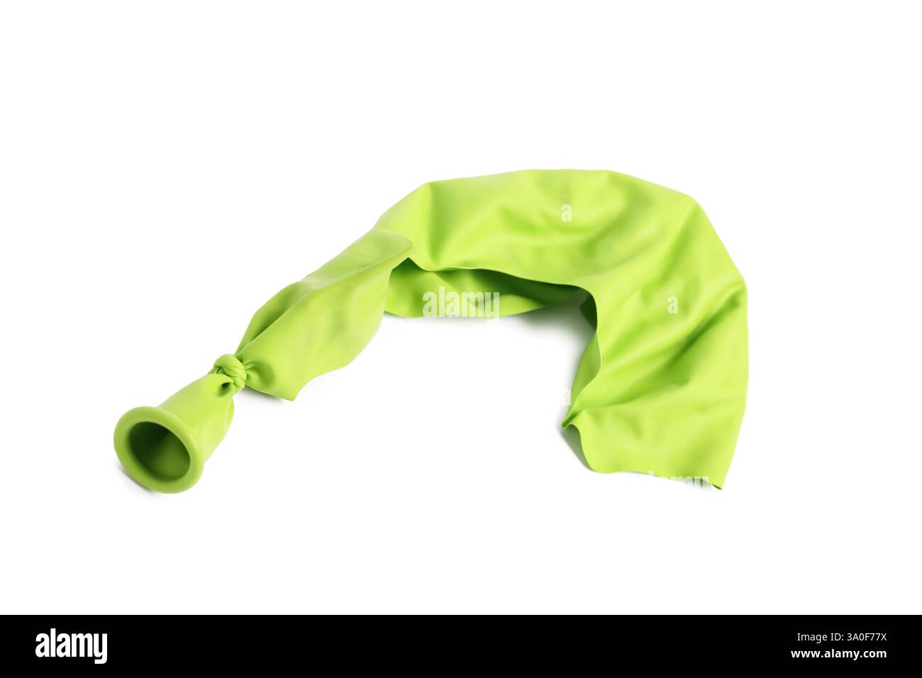 One green popped balloon isolated on white Stock Photo - Alamy