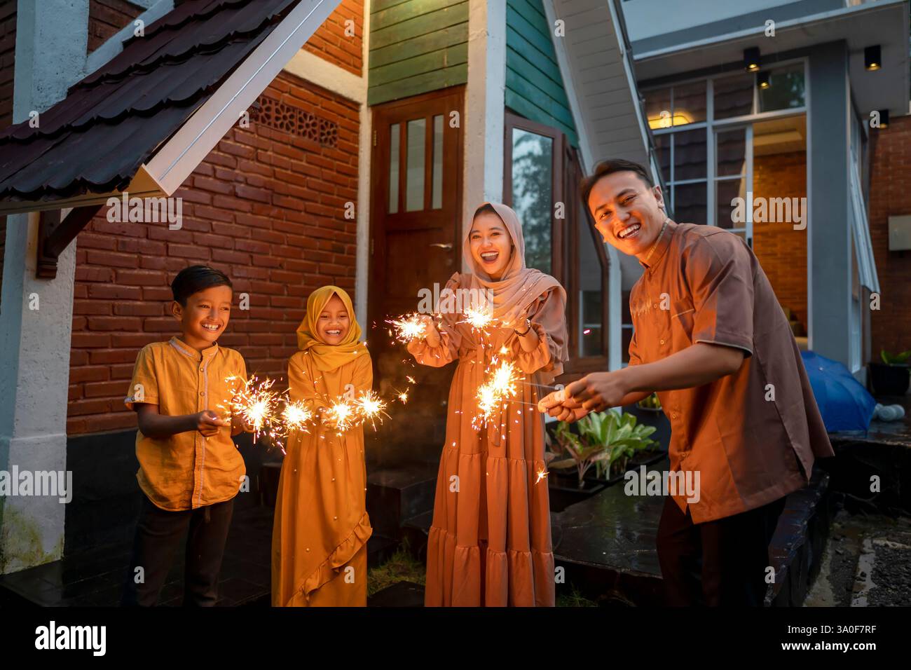 Asian Muslim family playing fireworks at hometown. Concept of Eid Al ...