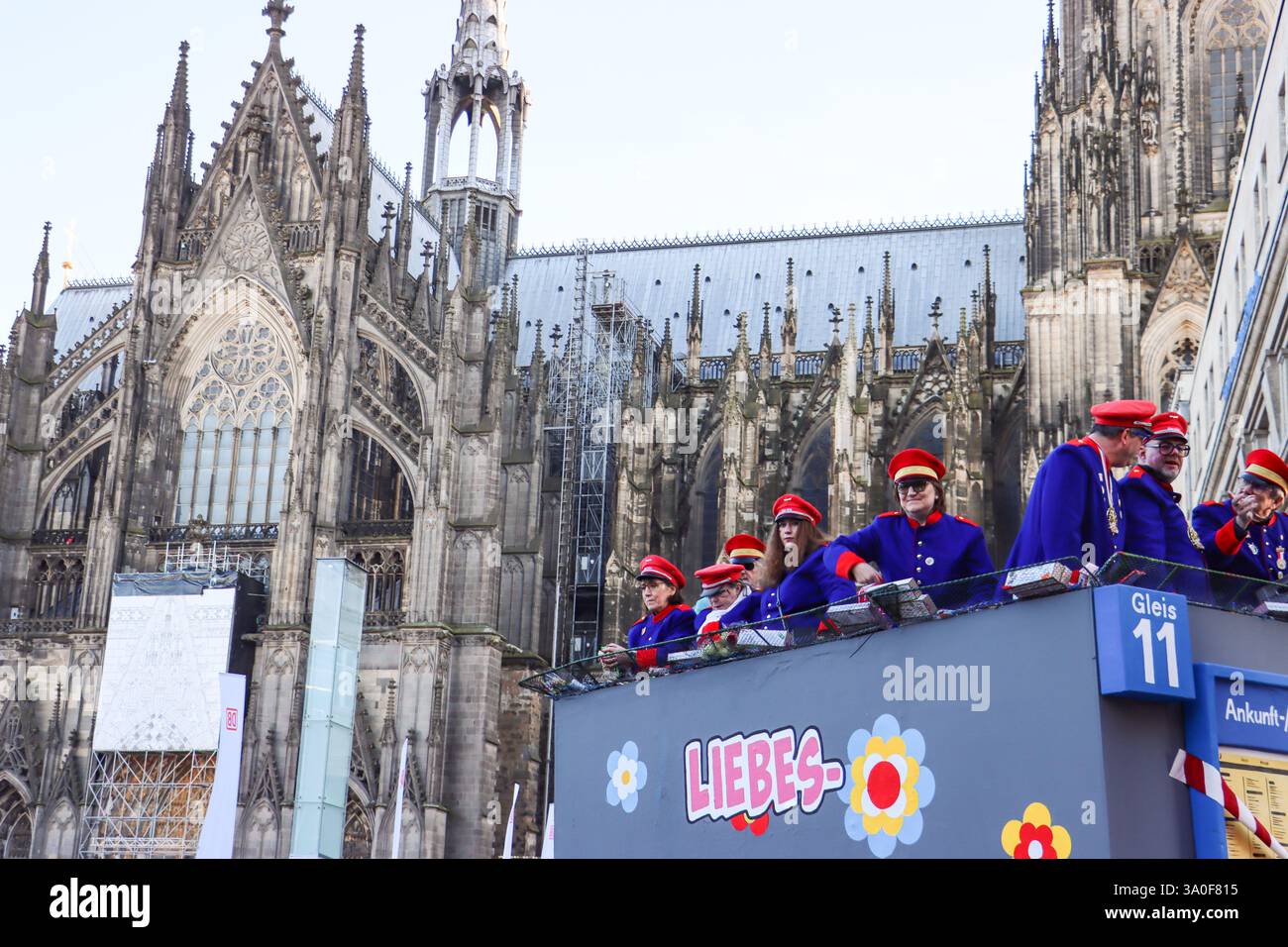 Cologne, Germany. 3rd Mar, 2025. Revelers cast candies and chocolates ...