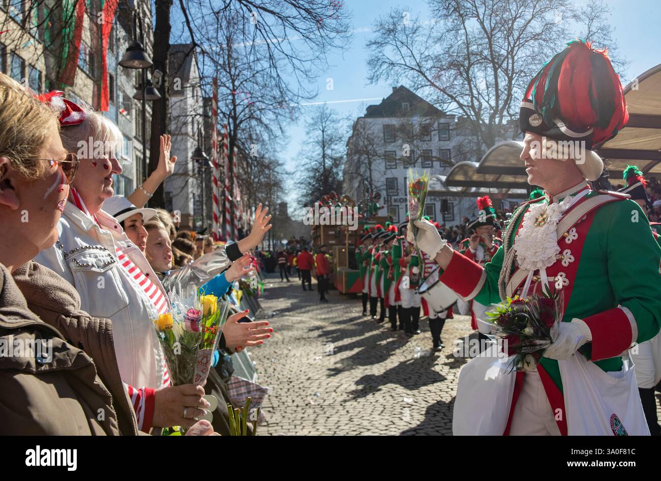 (250304) -- COLOGNE, March 4, 2025 (Xinhua) -- A reveler offers flowers ...