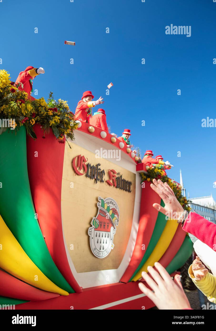 Cologne, Germany. 3rd Mar, 2025. Revelers cast candies and chocolates ...