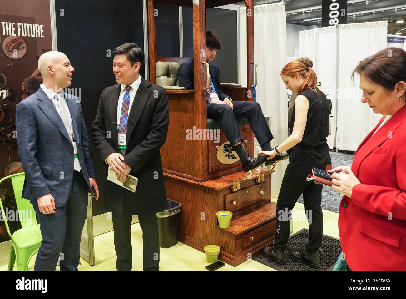 An attendee visits a shoe shine booth at the Prospectors, Developers ...