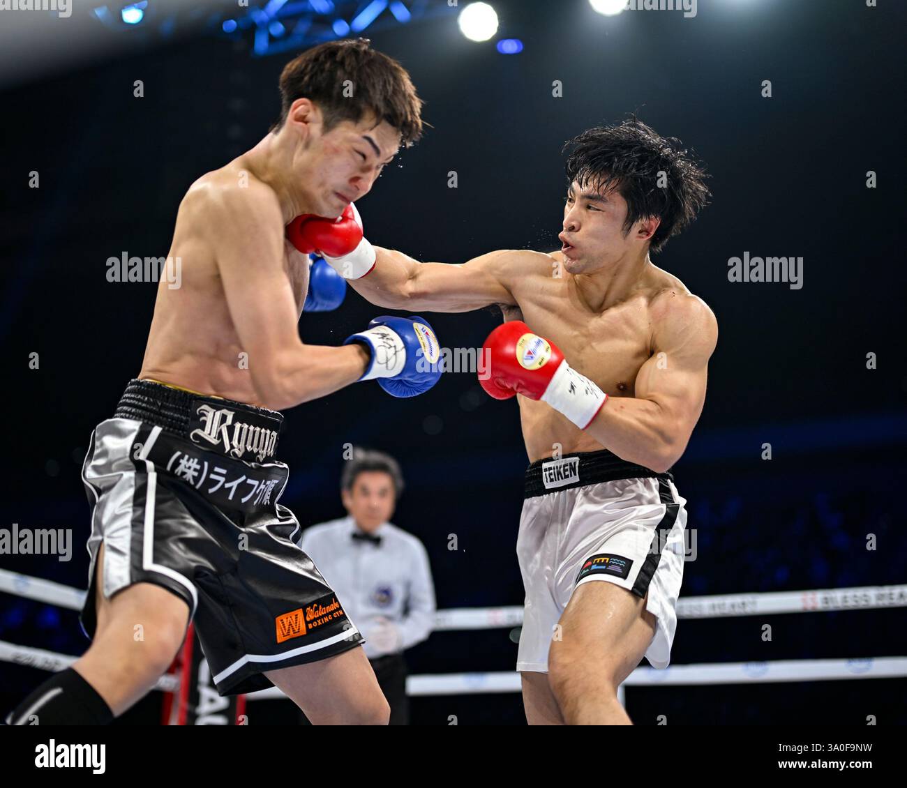 Eigoro Akai (red gloves) hits Ryuya Moriai (blue gloves) in the second ...