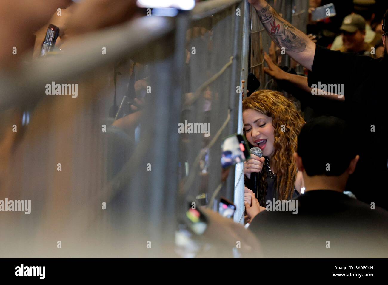 Colombian pop star Shakira sings to fans outside a hotel following the ...