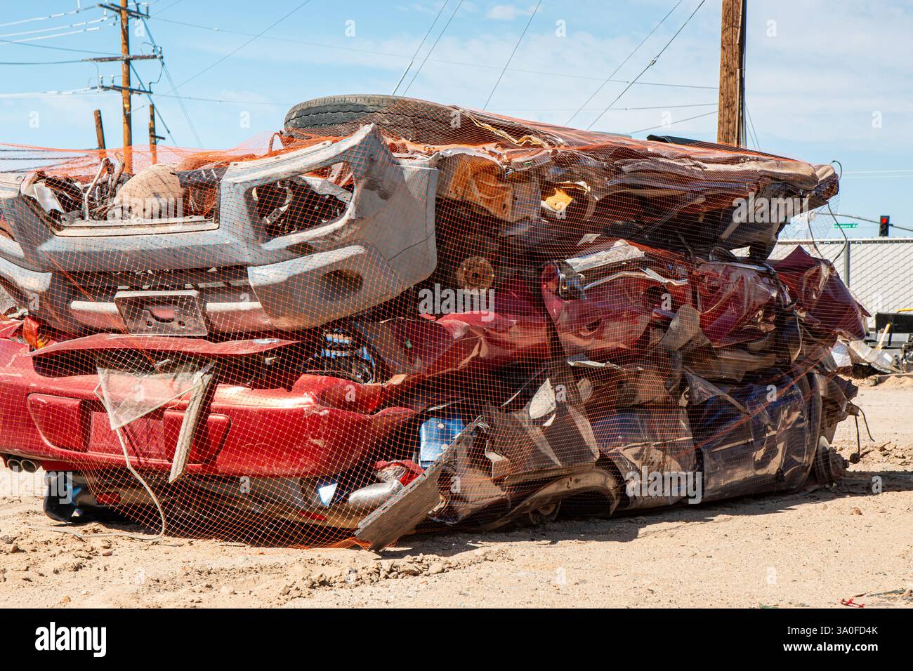 Compact cars smashed by the crusher at a salvage yard and stacked ready ...