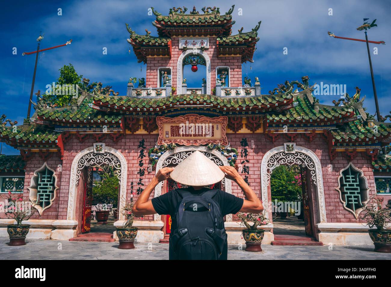 Tourist man walking at Fukian Assembly Hall in the Hoi An ancient town ...